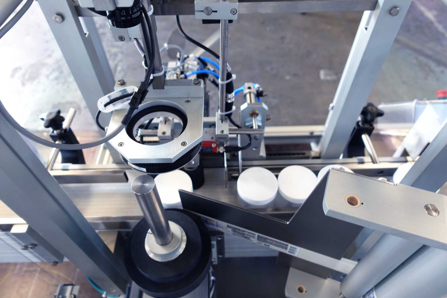 Labelling machines, label applicators and friction feeders